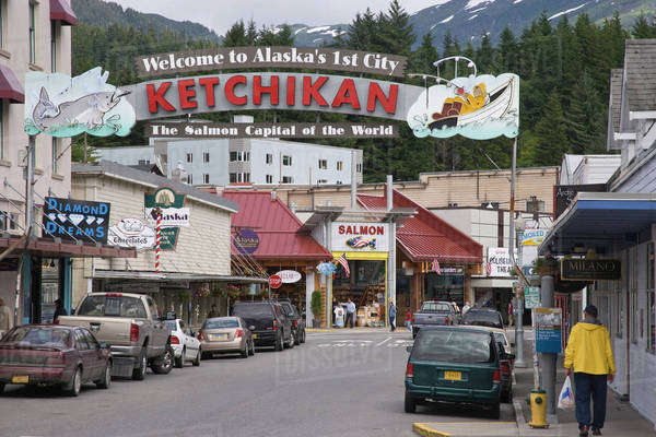 USA, Alaska, Ketchikan. Welcome sign spans street lined with stores ...