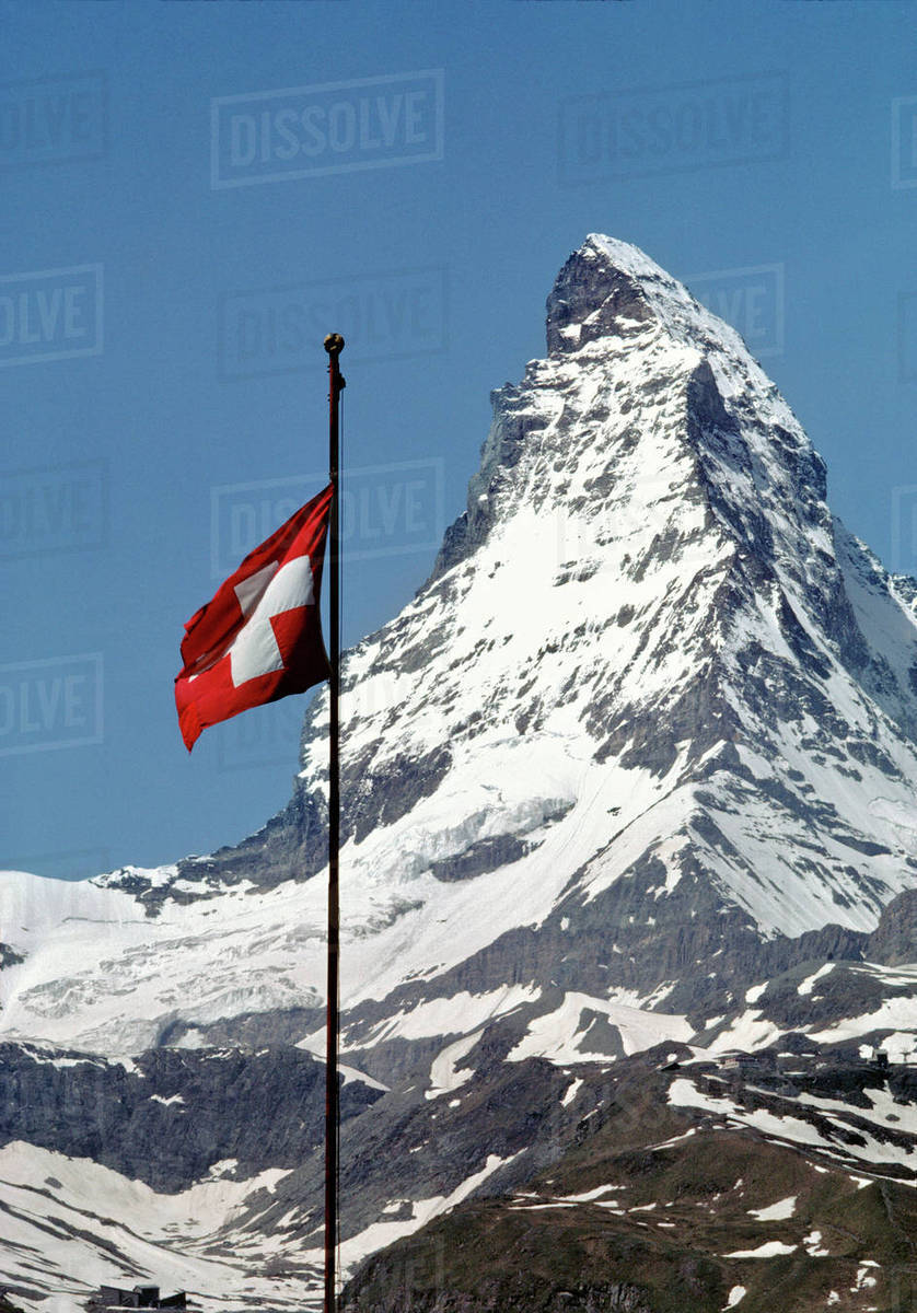 Europe, Switzerland, Matterhorn. The Swiss flag flies proudly at the ...