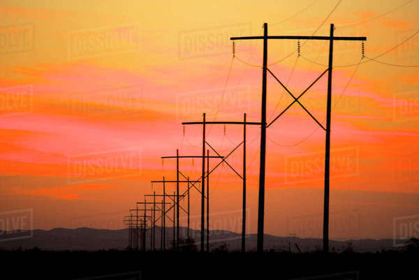 Power lines reach across the desert at sunset. - Royalty-free Stock ...