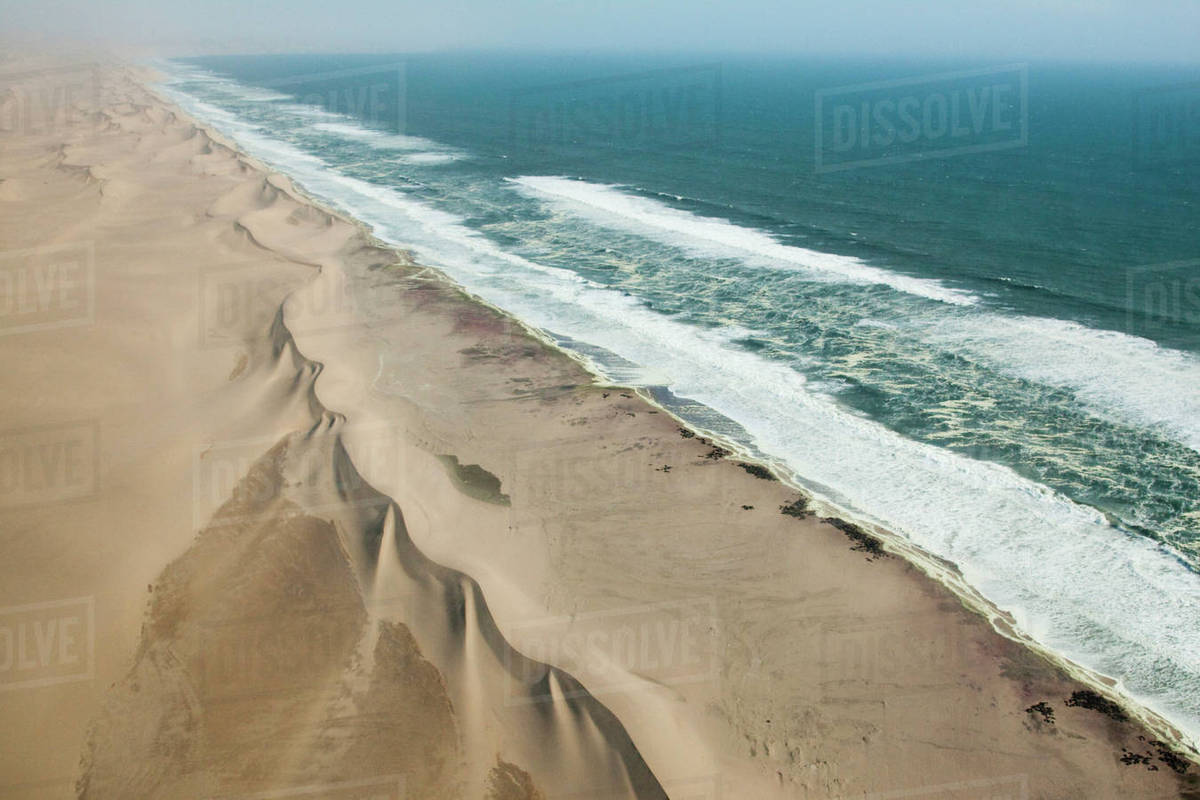 Namibia, Skeleton Coast. Aerial view of converging lines of sand and ...