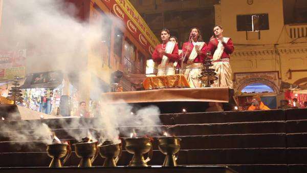 The Ganges River, Varanasi, India. A Sadhu Pouring Libations Into The ...