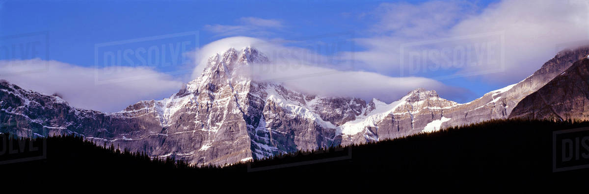 Canada, Alberta, Mt. Chephren. Wind whips the snow off Mt. Chephren in ...