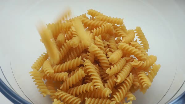 Uncooked fusilli, fusilli is a type of curled pasta, originally from ...