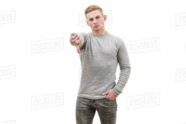 The man thumbs down on the white background - Stock Photo - Dissolve