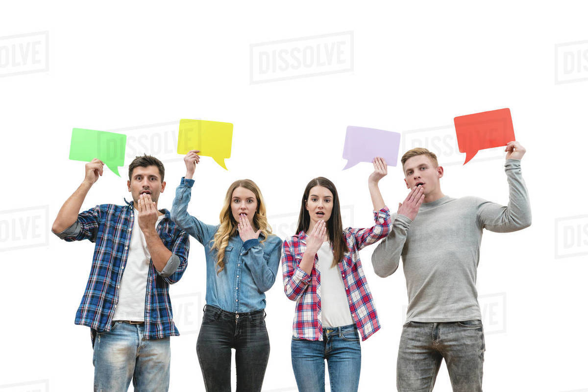 The four surprised people hold dialog signs on the white background ...