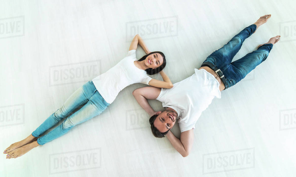 The happy man and a woman laying on the floor. view from above ...