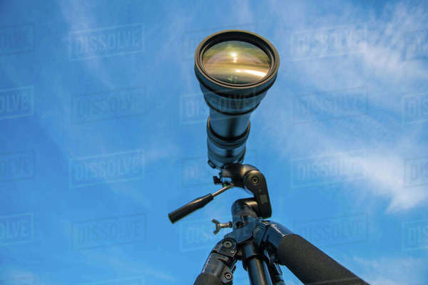 The camera with a lens on the blue sky background - Royalty-free Stock ...