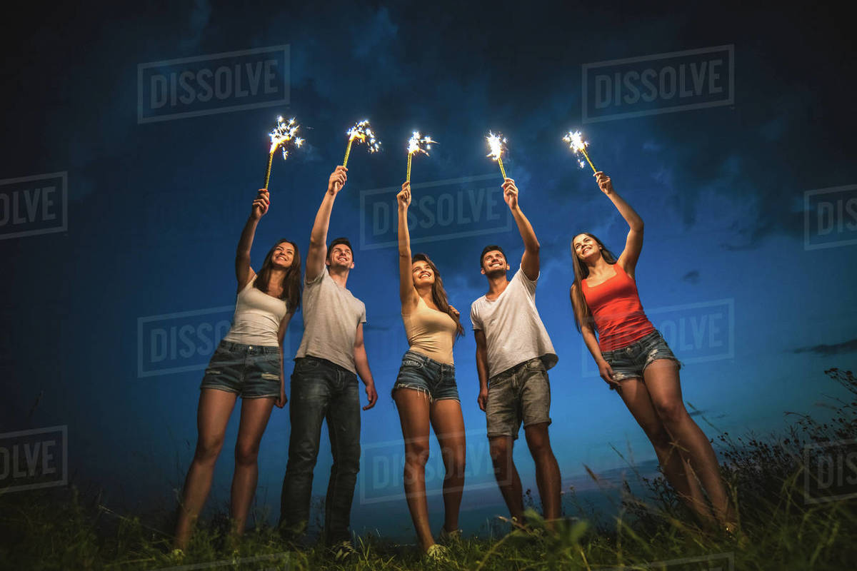 The smile friends hold firework sticks. evening night time - Stock ...