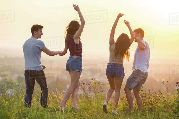 The four active people dancing on the grass - Royalty-free Stock Photo ...