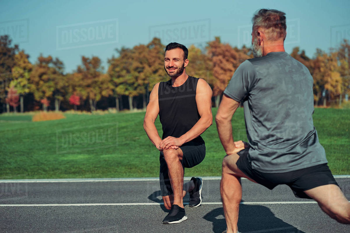 The two men doing exercise outdoor - Royalty-free Stock Photo | Dissolve