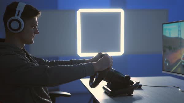 The young gamer playing video game on illuminated background - Stock ...