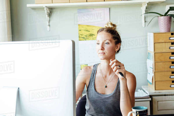 Woman in office using computer - Royalty-free Stock Photo | Dissolve