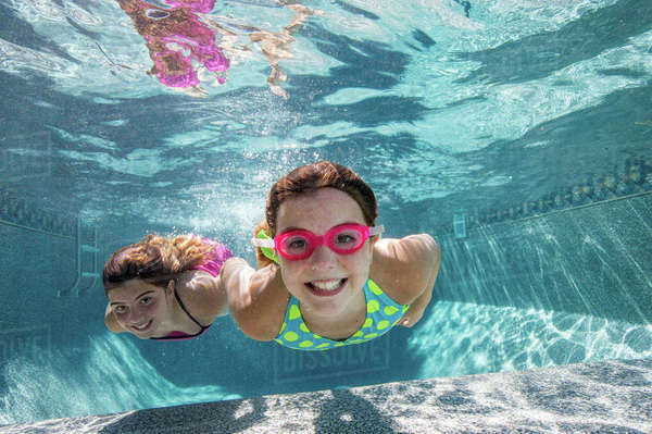 Girls swimming in pool - Royalty-free Stock Photo | Dissolve
