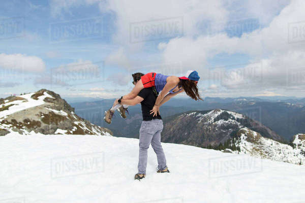 Man carrying woman over shoulder on mountain-top, Silver Star Mountain ...