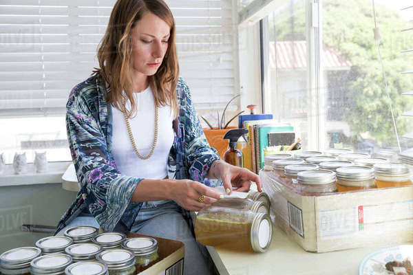 Women labelling jars - Royalty-free Stock Photo | Dissolve