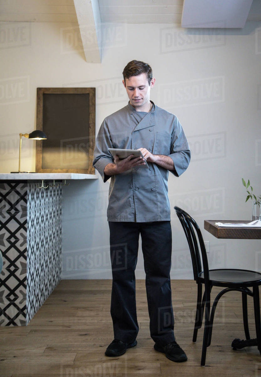 Portrait of waiter in restaurant, using digital tablet - Stock Photo ...