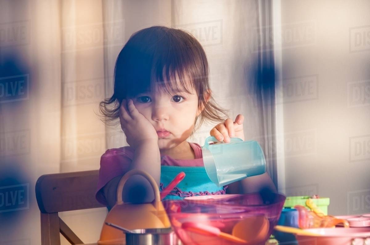 Sad girl playing with toys - Royalty-free Stock Photo | Dissolve