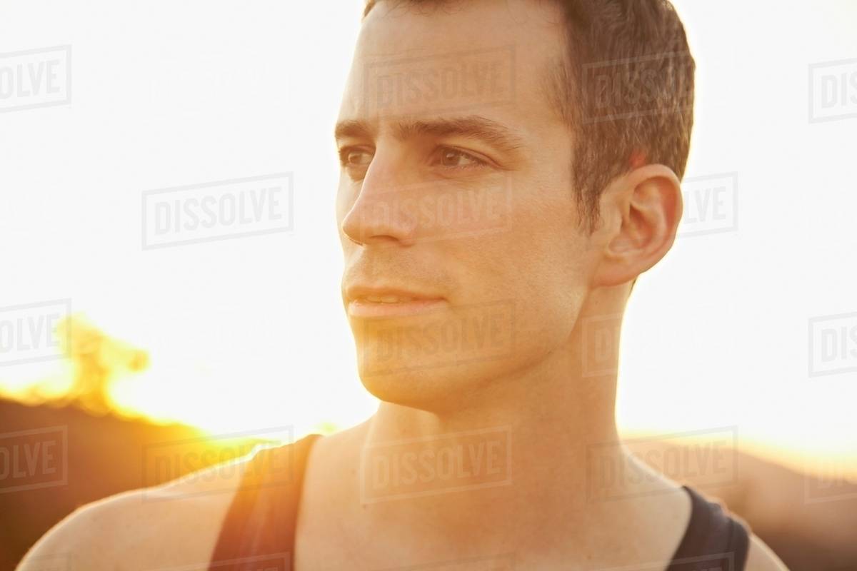 Man in singlet looking into distance - Royalty-free Stock Photo | Dissolve
