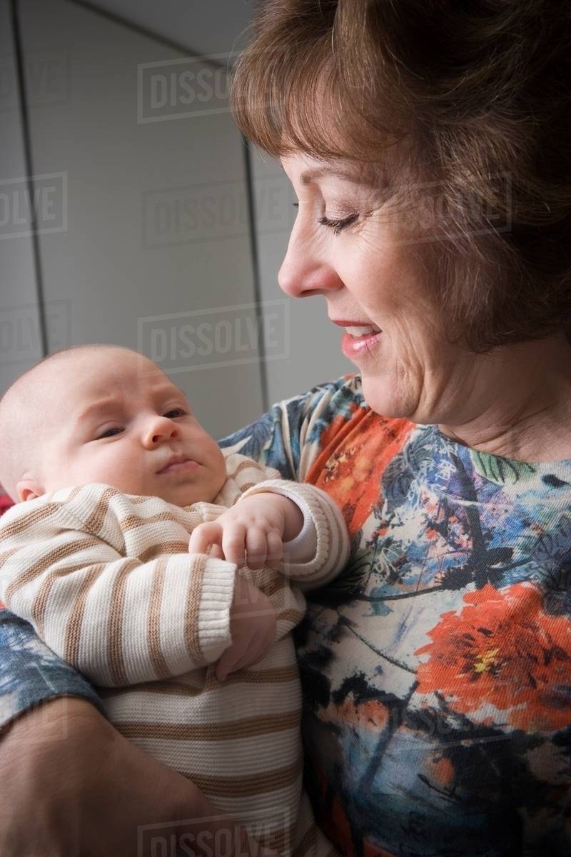 Senior woman holding baby boy, smiling - Royalty-free Stock Photo ...