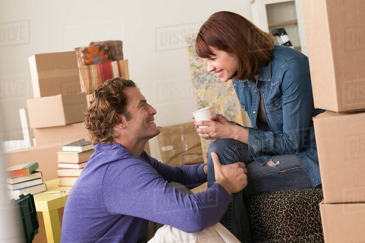 Couple taking a break whilst moving - Royalty-free Stock Photo | Dissolve