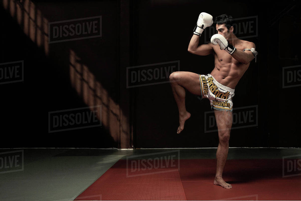 Boxer kicking on mat - Royalty-free Stock Photo | Dissolve