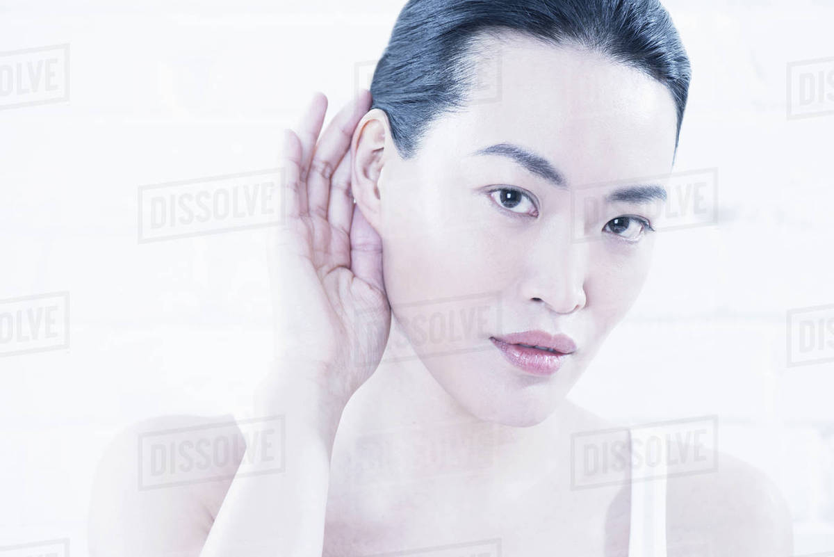 Close up of woman listening carefully - Royalty-free Stock Photo | Dissolve