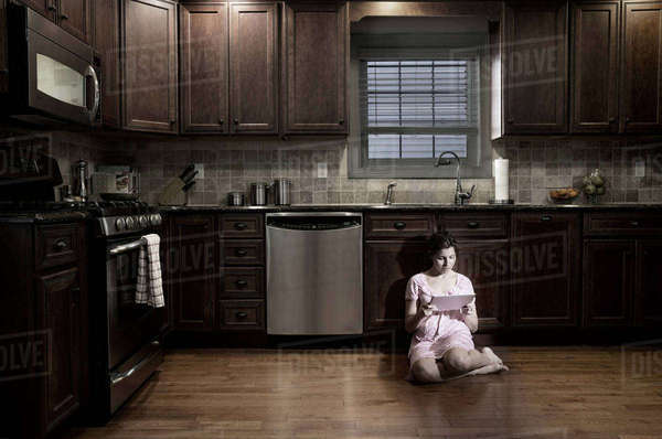 Woman in kitchen at night, using digital tablet - Royalty-free Stock ...