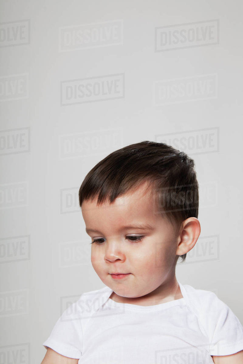 Baby boy looking down - Royalty-free Stock Photo | Dissolve