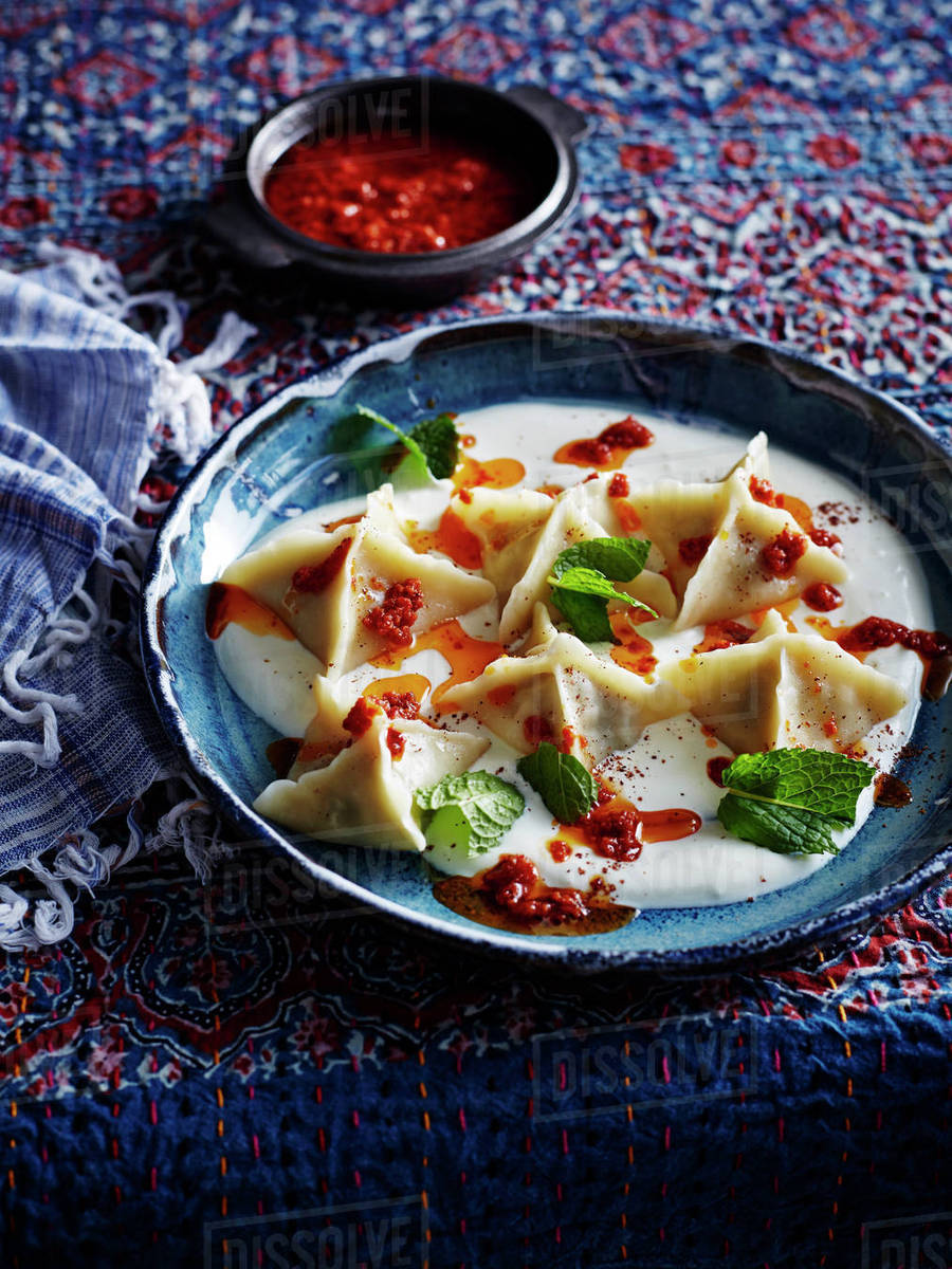 Turkish lamb manti with tomato and aleppo - Stock Photo - Dissolve