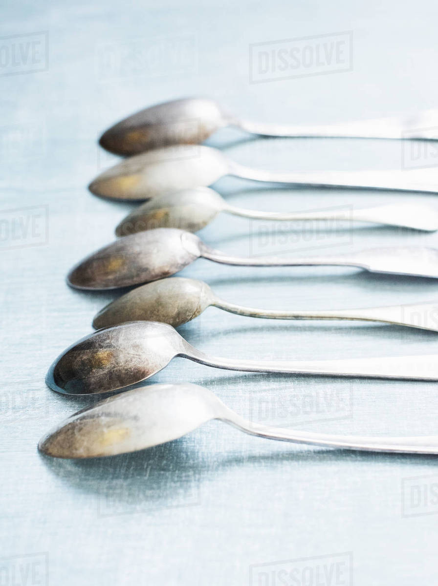 Row of spoons facedown - Royalty-free Stock Photo | Dissolve