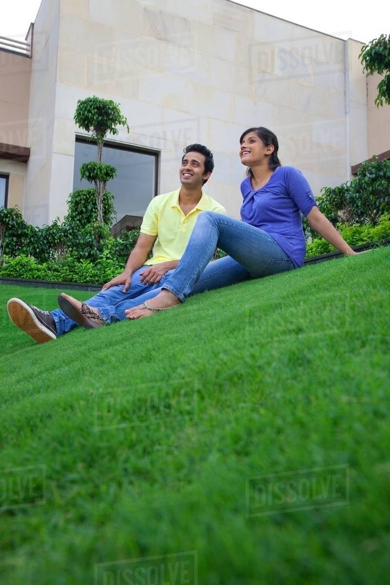 Couple sitting on a lawn - Royalty-free Stock Photo | Dissolve