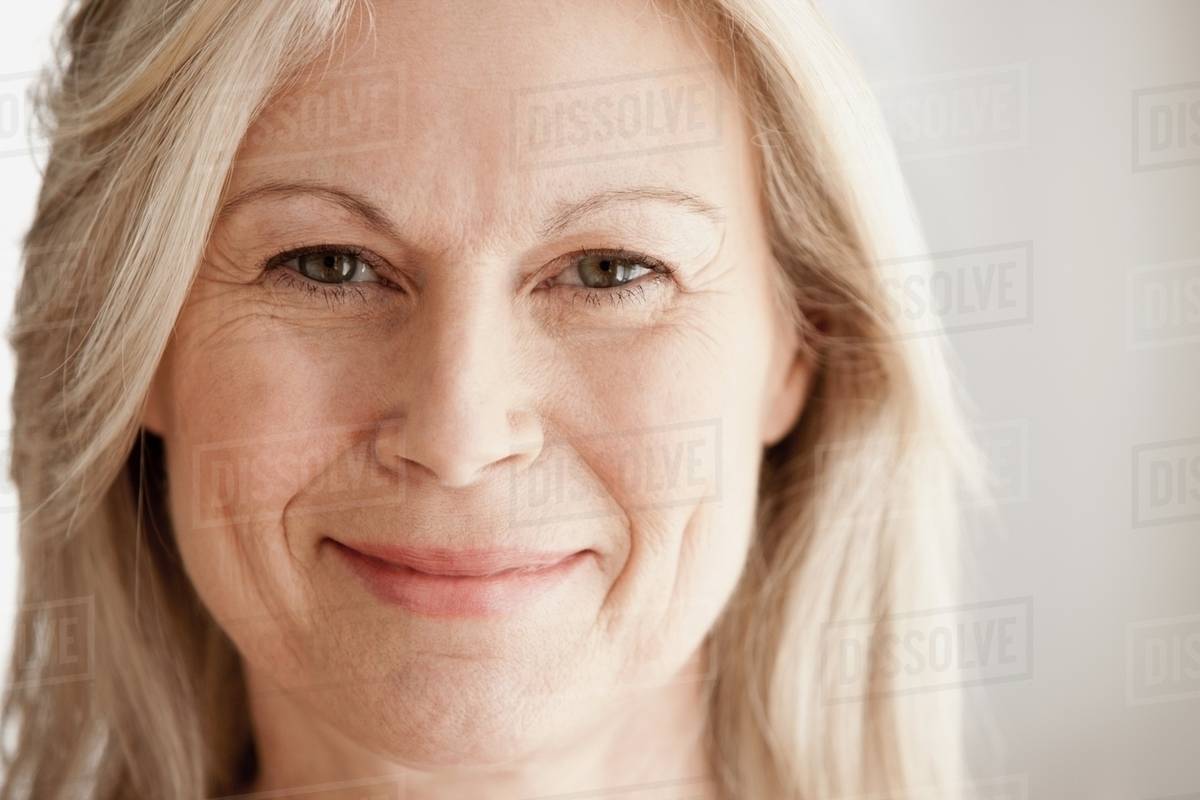 Portrait of mature woman, smiling - Royalty-free Stock Photo | Dissolve
