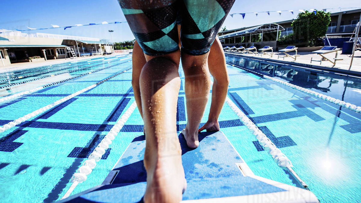 Swimmer on pool diving board - Stock Photo - Dissolve