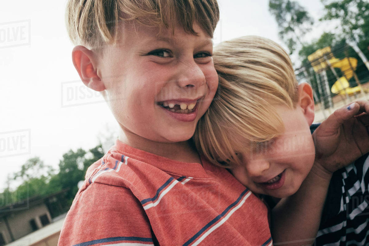 Portrait of two boys in playground, smiling - Stock Photo - Dissolve