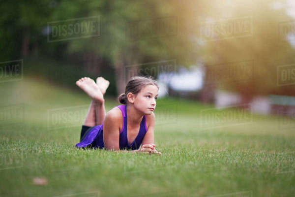 Girl lying on front on grass - Royalty-free Stock Photo | Dissolve