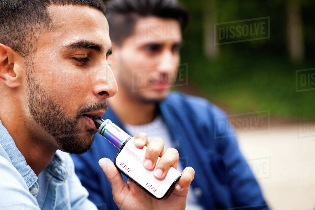 Man using vape - Royalty-free Stock Photo | Dissolve