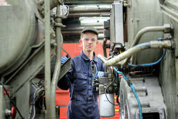 Portrait of young apprentice locomotive engineer in train works - Stock ...