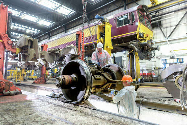 Locomotive engineers working on locomotive in train works - Stock Photo ...