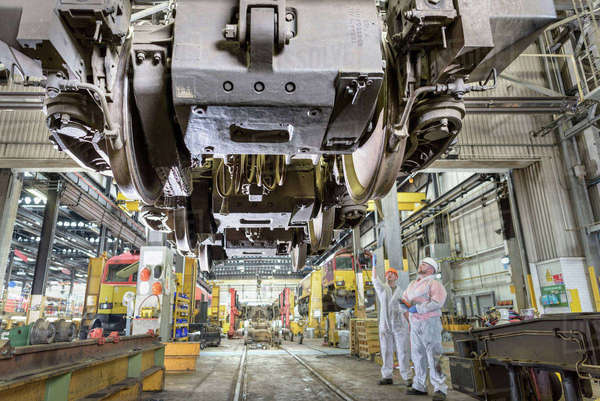 Locomotive engineers working on locomotive in train works - Stock Photo ...