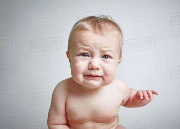 Baby boy looking upset - Royalty-free Stock Photo | Dissolve