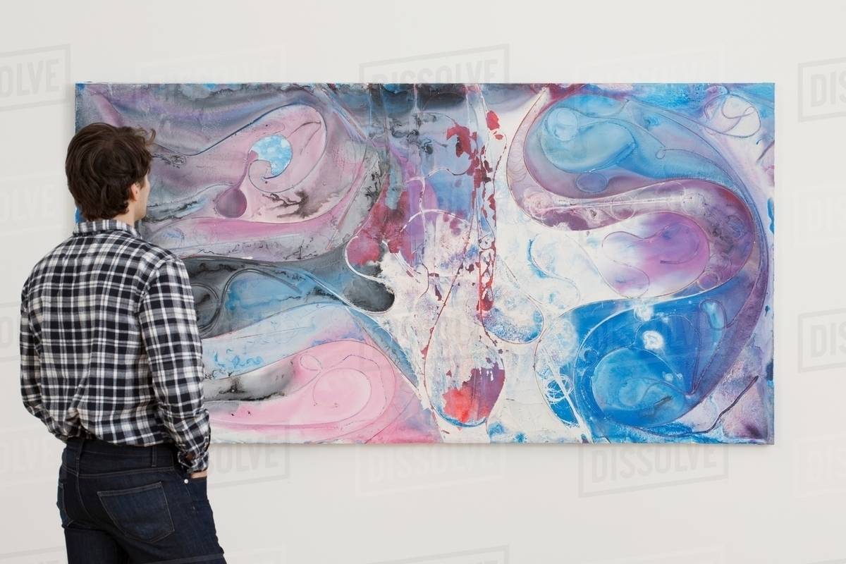 Young man looking at oil painting in gallery - Royalty-free Stock Photo ...