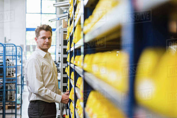Portrait of factory manager in factory warehouse - Stock Photo - Dissolve