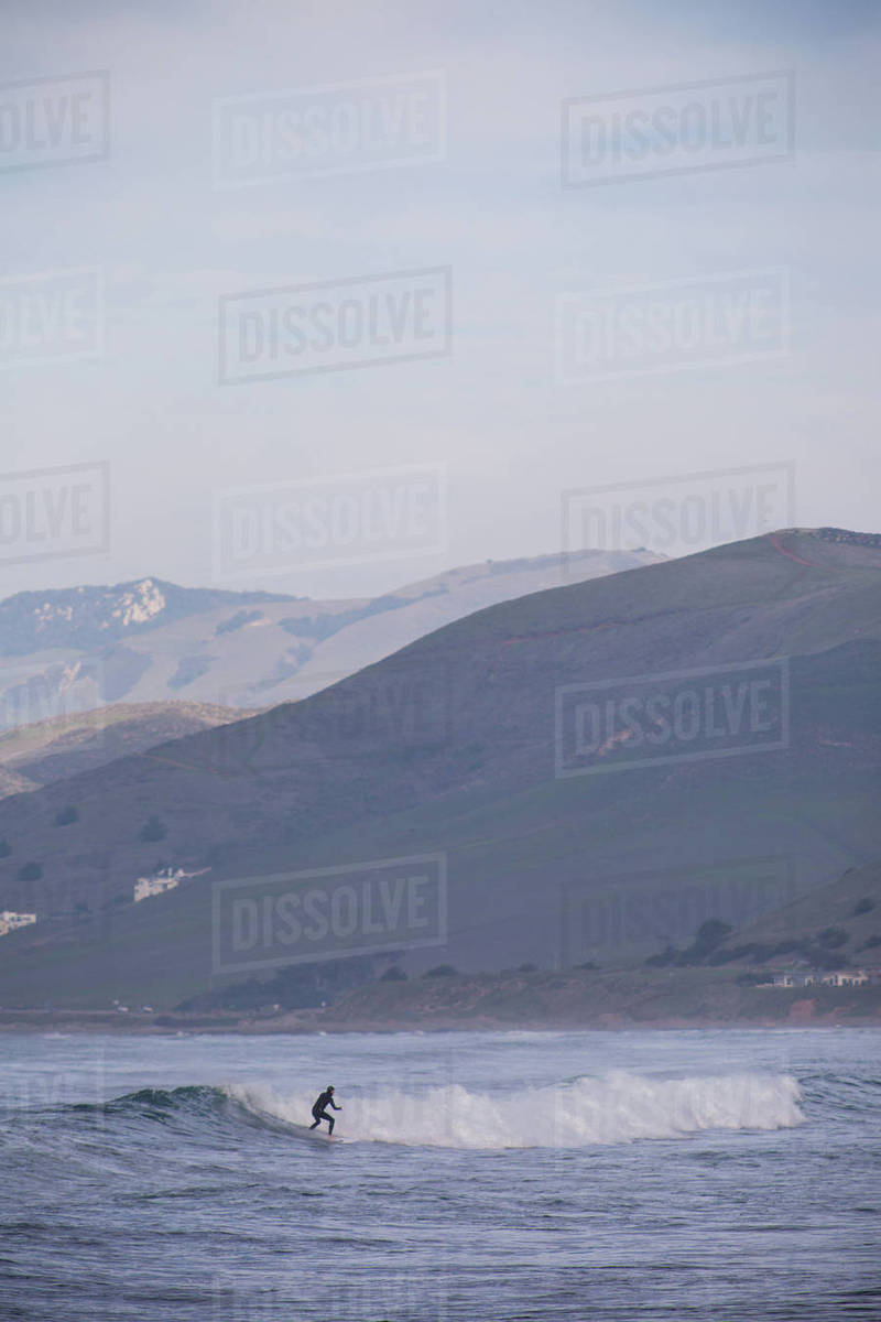 Young male surfer surfing ocean wave, Morro Bay, California, USA ...