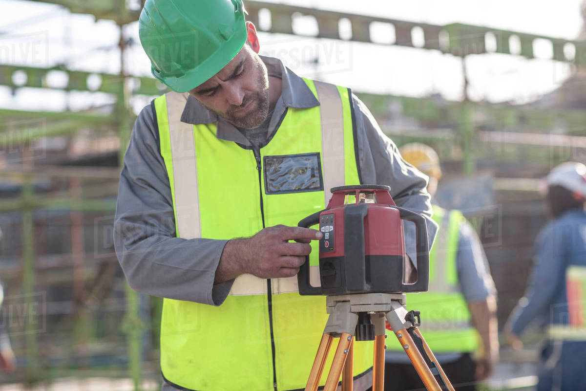 Construction worker using surveying equipment - Royalty-free Stock ...