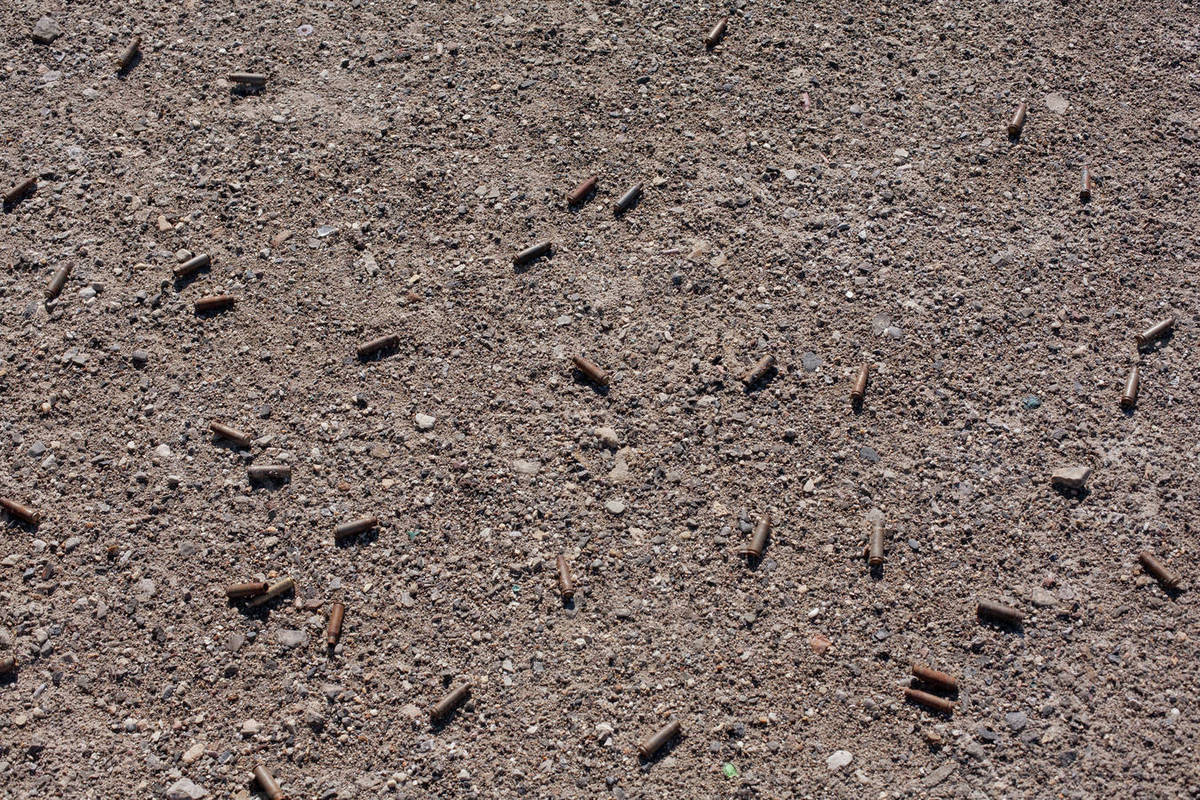 Overhead view of bullet casings from semi automatic weapon at firing ...