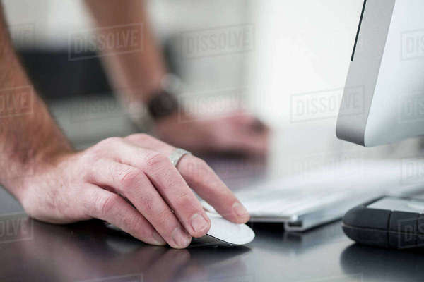 Cropped view of man using computer mouse - Royalty-free Stock Photo ...