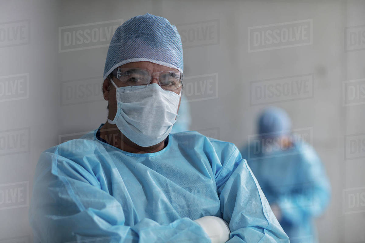 Portrait of male surgeon wearing scrubs and surgical mask - Royalty ...