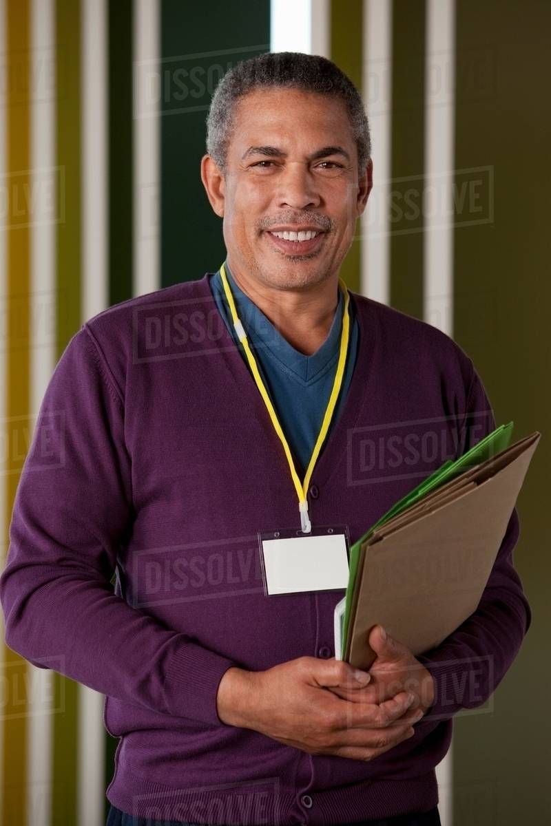 Man holding files, portrait - Royalty-free Stock Photo | Dissolve