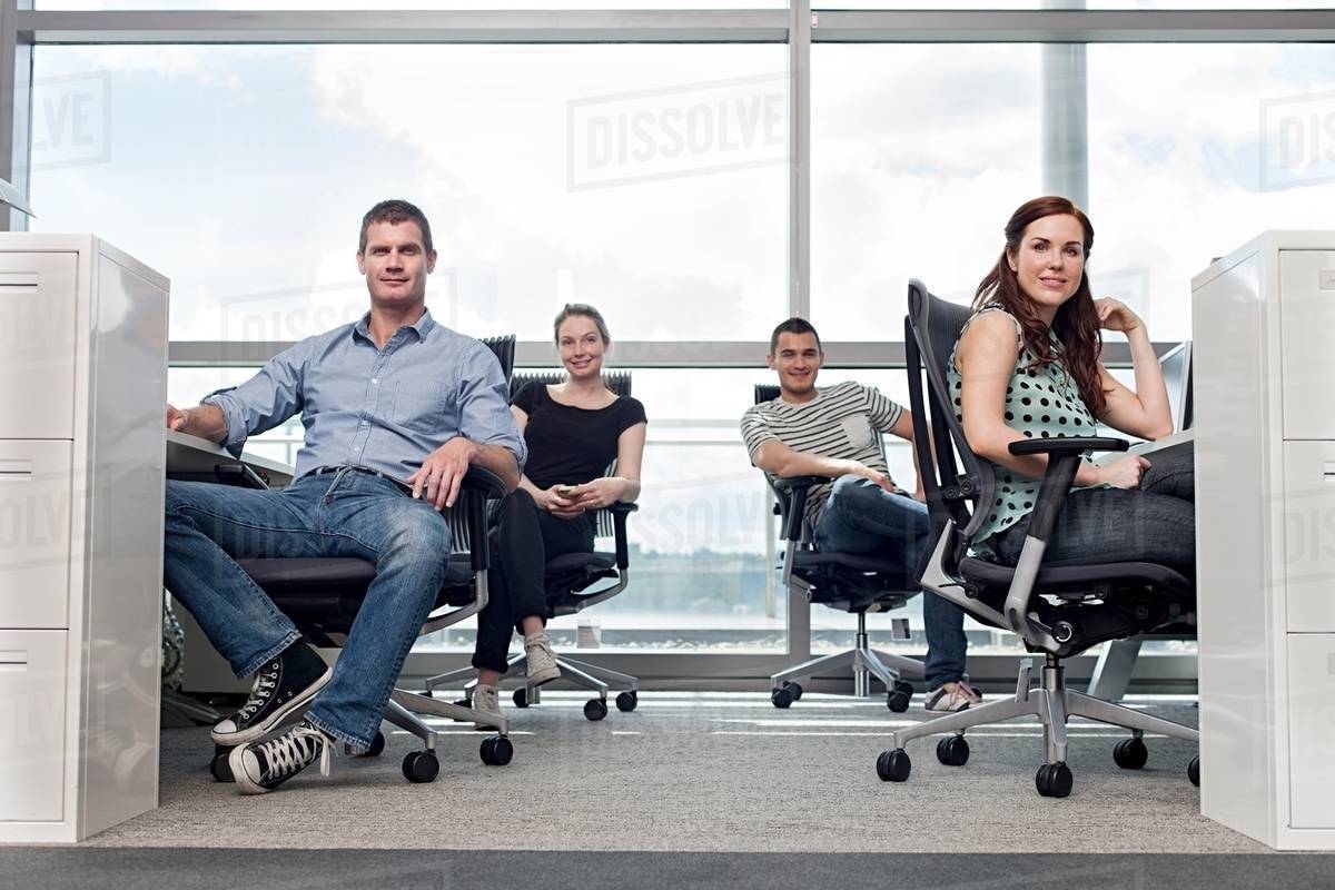 Creative business people sitting at workstations - Royalty-free Stock ...