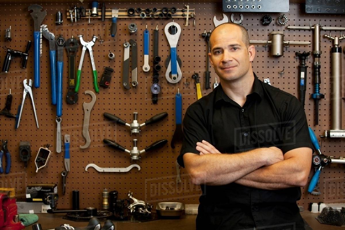 Man in front of wall of tools in workshop - Royalty-free Stock Photo ...